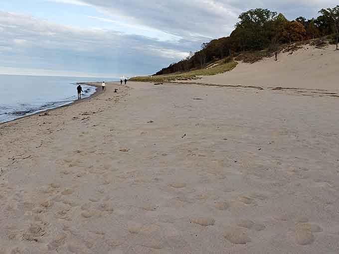 Early morning beachcombers enjoy solitude along Indiana Dunes' shoreline, where footprints in the sand become temporary signatures on nature's canvas.