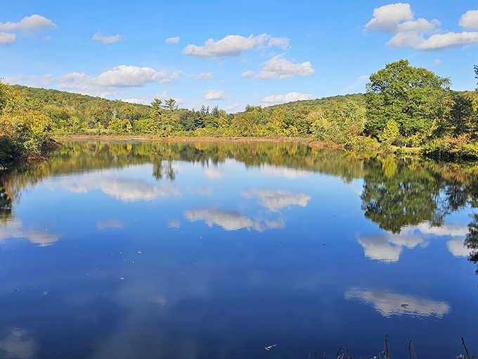 Mirror, mirror on the lake! Shepherd Lake's glassy surface perfectly captures the Ramapo Mountains, creating nature's own Instagram filter without the need for hashtags.