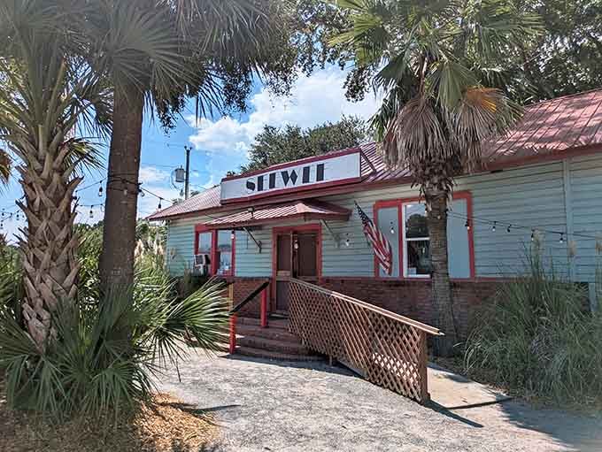 That white exterior with the red roof isn't just charming, it's practically a beacon calling hungry travelers home.