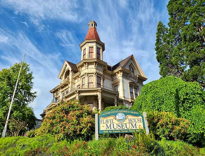 The Flavel House Museum rises like a Victorian wedding cake, all towers and gingerbread trim that makes modern architecture weep.