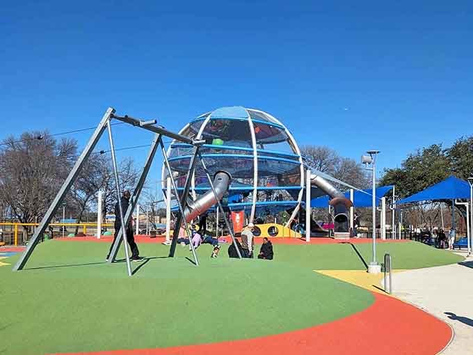The main climbing structure towers like a futuristic playground palace, complete with slides spiraling down from the clouds.