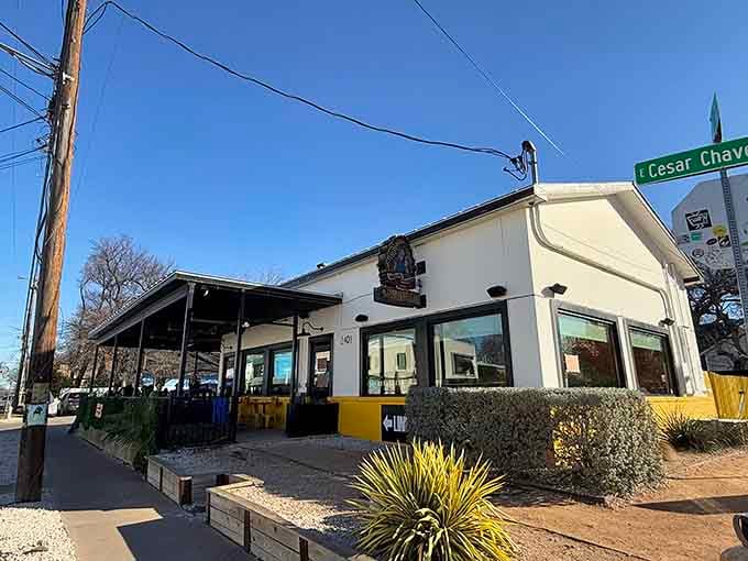 The white building with yellow accents looks unassuming, but behind those walls, post oak works its magic on brisket destined for greatness.