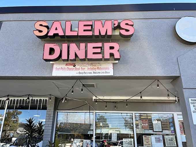 That pink and gray sign isn't just marking a restaurant, it's announcing a Birmingham institution worth finding.