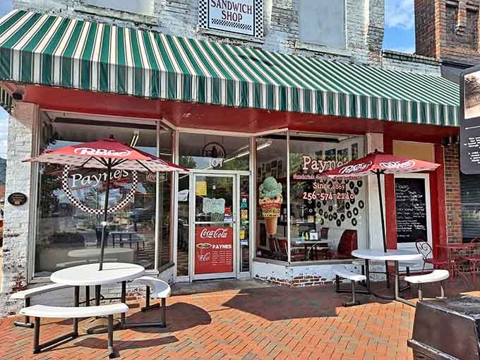 That striped awning and brick patio whisper "come sit awhile" louder than any neon sign ever could.