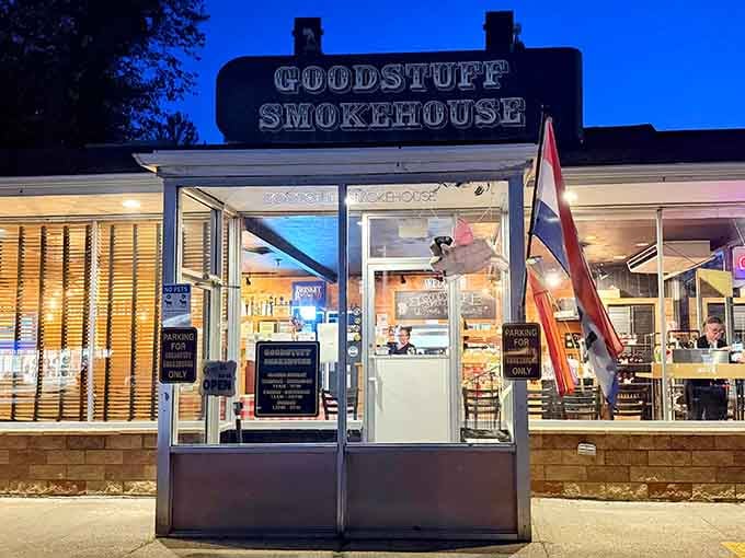 The blue evening sky frames this BBQ sanctuary like nature's perfect backdrop. Goodstuff Smokehouse beckons hungry travelers with its warm glow and promise of smoky delights.