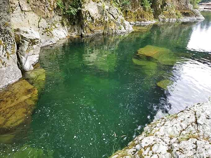 That emerald green water isn't just photogenic, it's swimmable too, though your body will definitely remind you it's snowmelt-fed creek water.