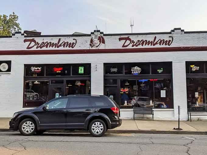 That white exterior with red lettering isn't fancy, but it's been calling barbecue pilgrims home for decades.