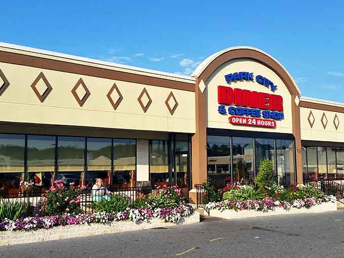 Spring brings a burst of color to the diner's entrance, where vibrant flowers create the perfect prelude to the culinary delights waiting inside. Nature's appetizer, if you will.