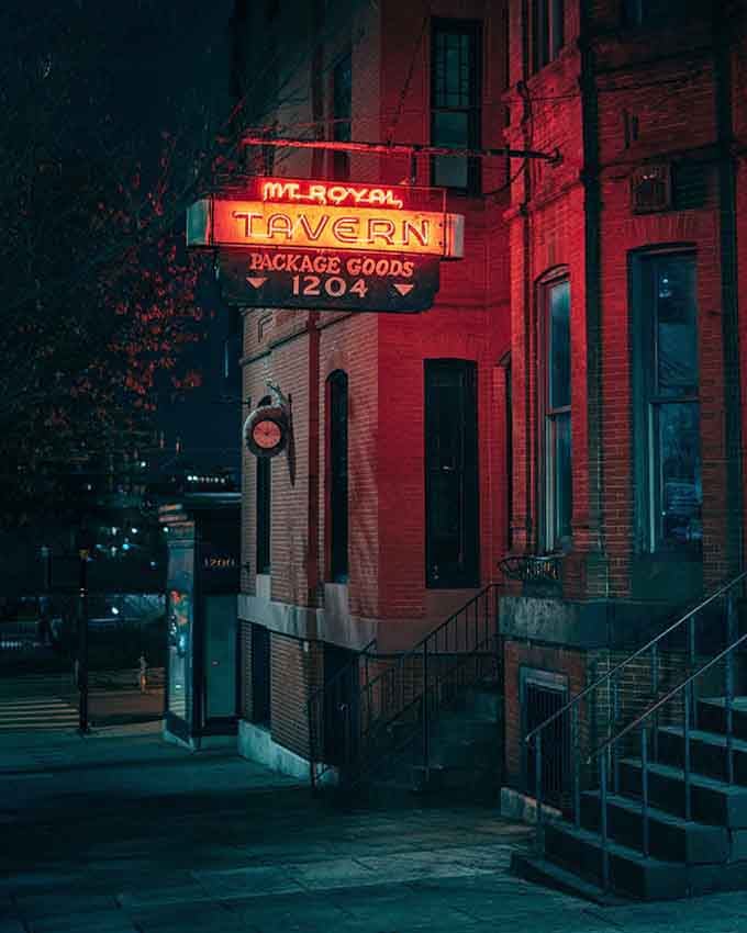 That neon glow isn't just a sign, it's a beacon calling you home to Baltimore's most gloriously cluttered dive bar.