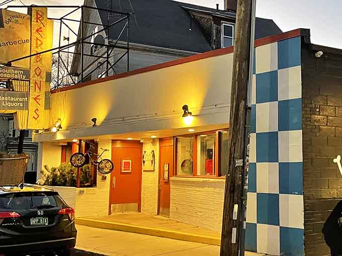 That checkerboard pattern and warm glow practically scream "serious barbecue lives here, come hungry and leave happy."