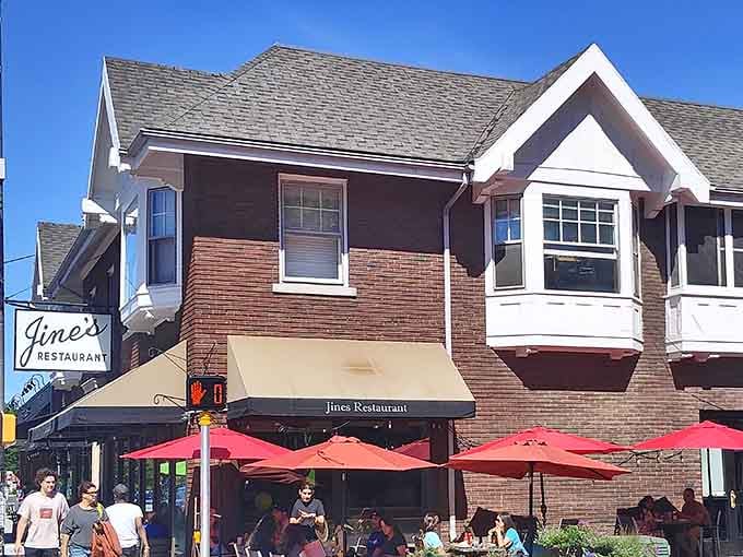 That brick facade and those red umbrellas are calling your name louder than your alarm clock ever could.