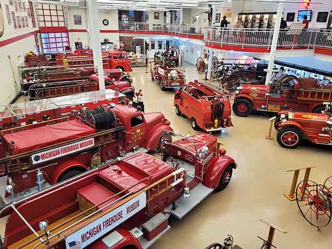 A sea of gleaming red fire trucks stretches across the museum floor like a vintage dream come true.
