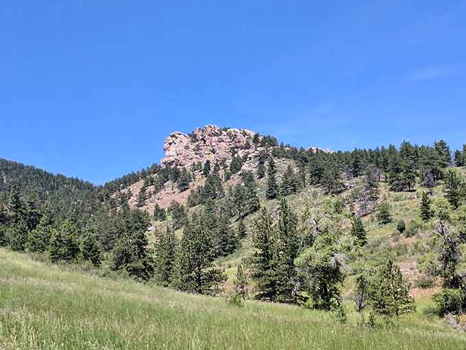 Arthur's Rock stands majestically against Colorado's impossibly blue sky, beckoning hikers to conquer its 1,000-foot elevation gain.