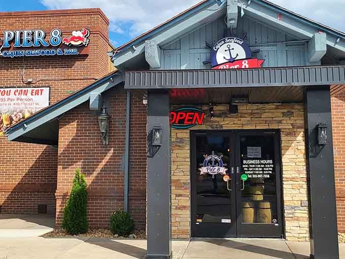 The nautical-themed entrance with its anchor logo promises coastal flavors hiding behind those charming double doors.