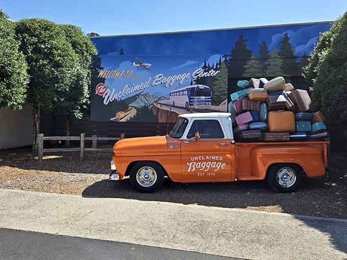 That vintage orange pickup truck loaded with colorful luggage is basically Instagram gold before you even walk inside.