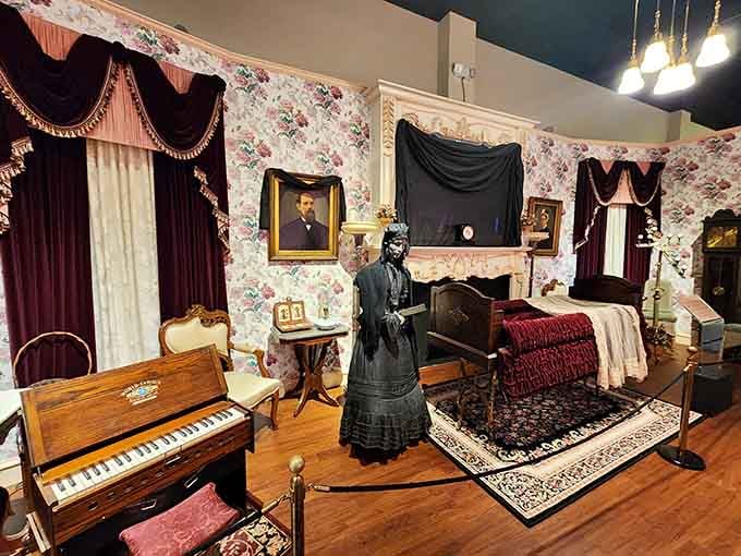 Victorian mourning meets museum magic in this recreated parlor scene complete with period dress and ornate furnishings.