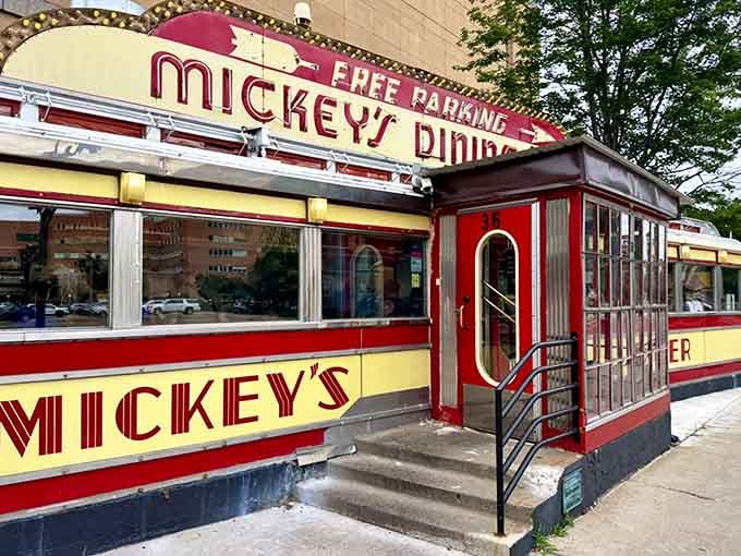 That red and yellow art deco exterior isn't just pretty, it's a neon-lit time capsule on wheels.