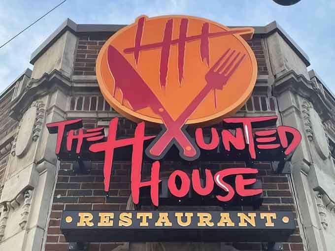 That neon sign glowing against the historic brick facade is basically screaming "come get your spooky dinner on!"