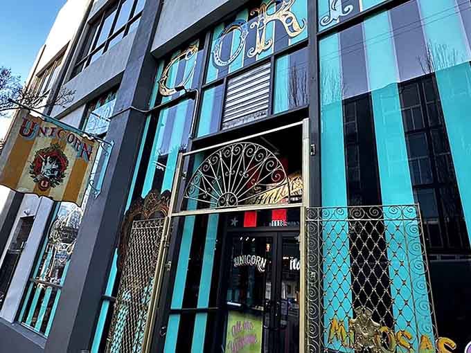 Those turquoise stripes and ornate metalwork frame the doorway like a portal to another dimension, which honestly isn't far off.