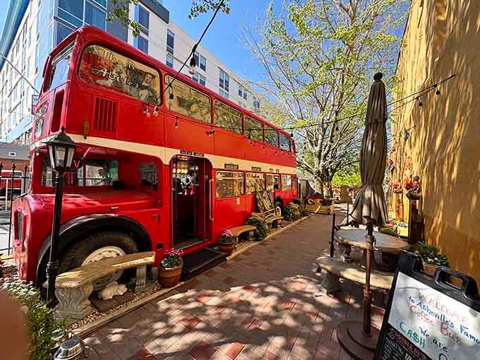 That magnificent red double-decker bus isn't lost; it found its perfect home serving coffee and joy in downtown Asheville.