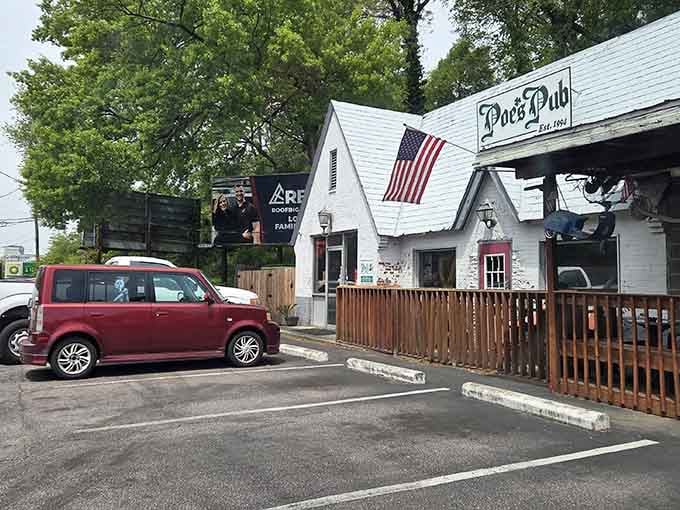 That charming white cottage exterior promises literary adventures and seriously good eats inside Poe's Pub.