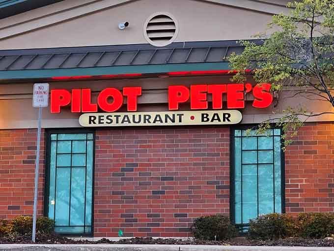 The bright red sign beckons like a beacon for hungry aviation enthusiasts and curious suburbanites alike.