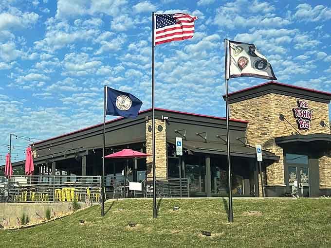 Those flags flying proudly under a perfect blue sky tell you everything about this place before you even walk in.
