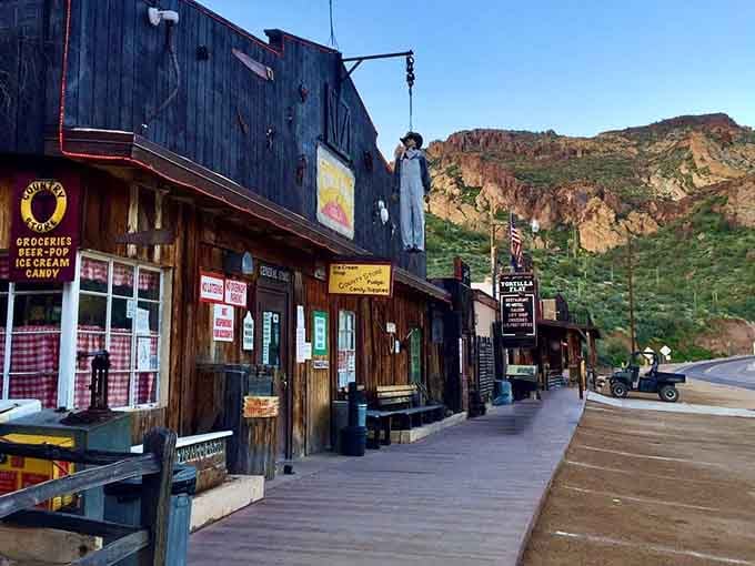 The wooden boardwalk and mountain backdrop prove that some places refuse to join the 21st century, bless their hearts.
