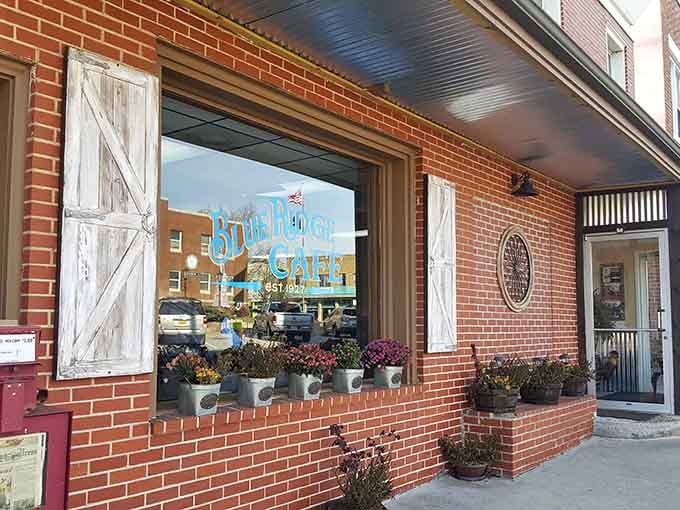 Those weathered barn-style shutters and potted mums say "small-town charm" louder than any fancy marketing campaign ever could.