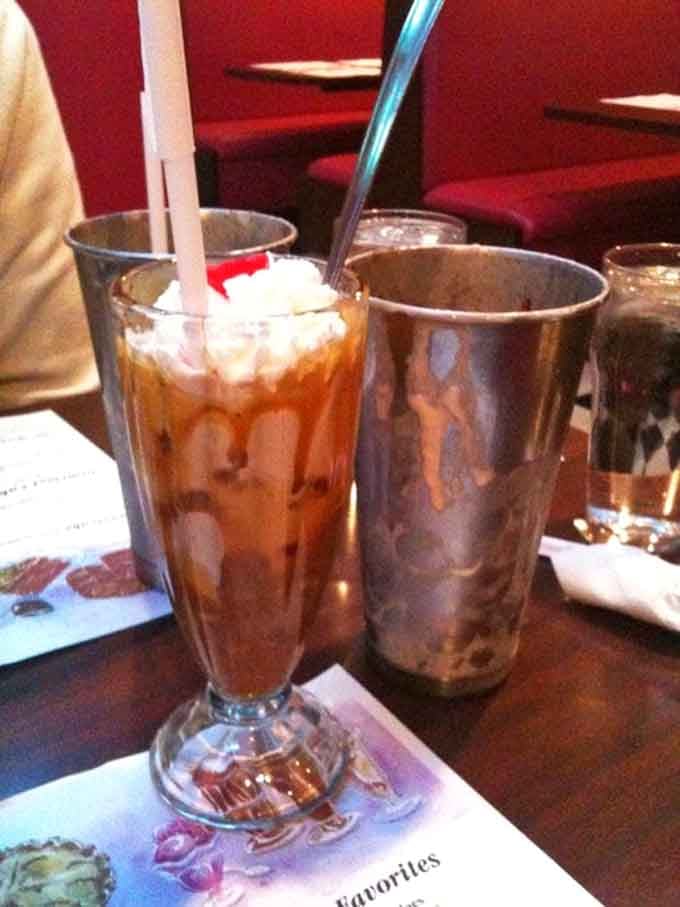 Turtle malt served in a classic glass with enough whipped cream to require its own zip code.