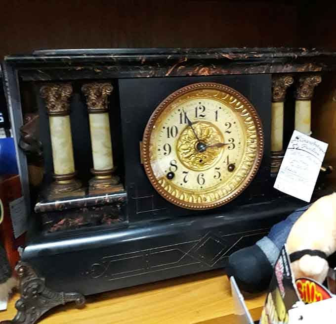 This antique mantel clock has survived more decades than most marriages, still ticking with that ornate Victorian confidence and style.