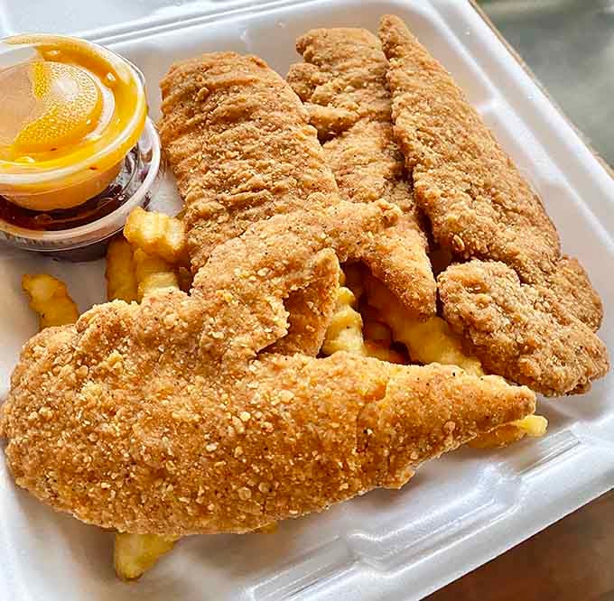 Golden chicken tenders with fries that prove the deep fryer is one of humanity's greatest inventions when used correctly.