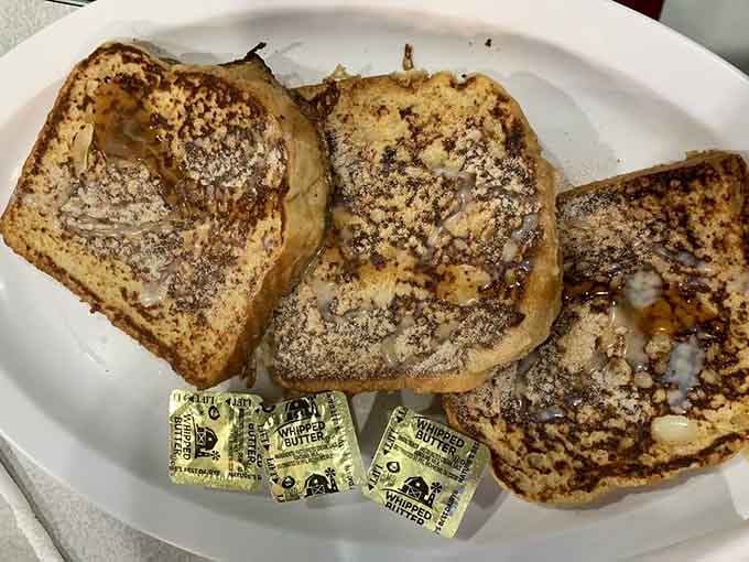 French toast so thick and golden it looks like it belongs in a museum, or more appropriately, your stomach.