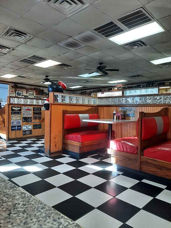 Those checkered floors and red vinyl booths aren't reproductions; they're the genuine article from a better era.
