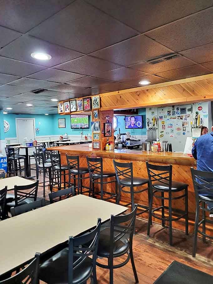 The bar area strikes that perfect balance between sports pub and seafood shack, with turquoise walls and wooden accents creating a distinctly coastal vibe.