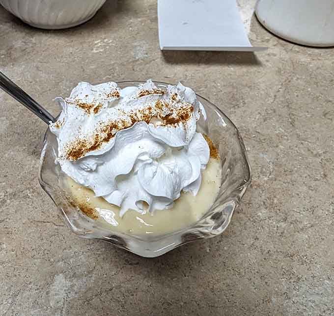 Tapioca pudding topped with whipped cream: a sweet ending that tastes like childhood memories.