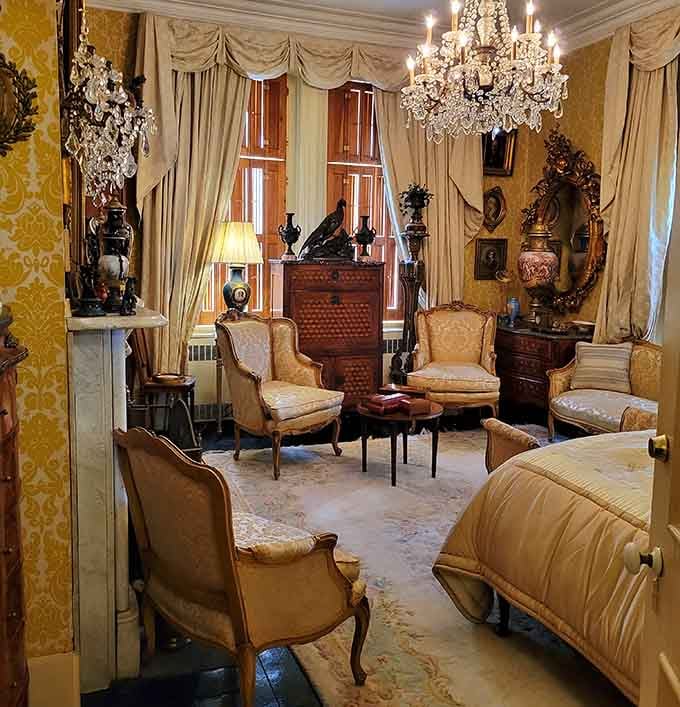 A bedroom so ornate that sleeping here would feel like napping inside a jewelry box from heaven.