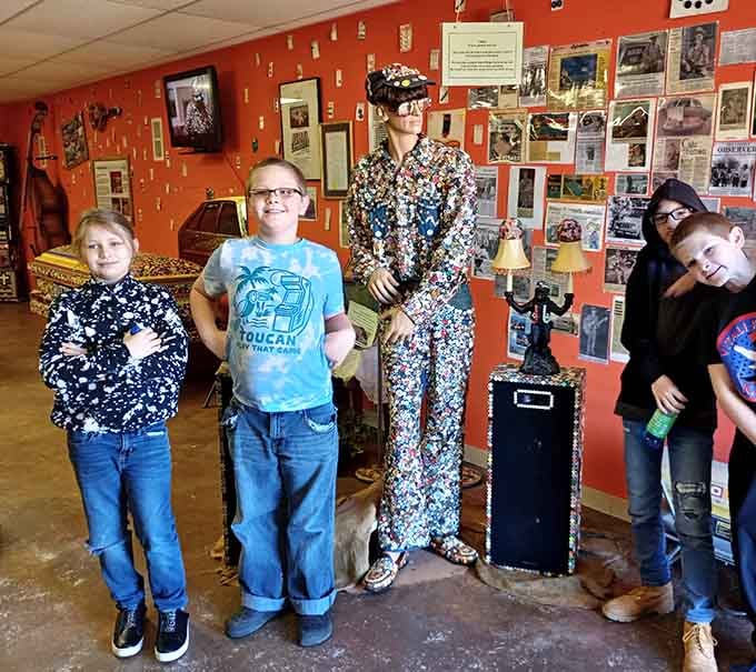 Young visitors stand amazed next to the button-suited mannequin, already planning their show-and-tell presentation for Monday.