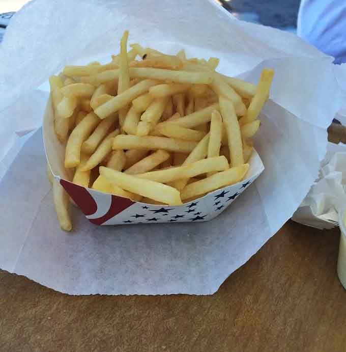 A mountain of fries that could feed a small army or one very determined person with excellent life priorities.