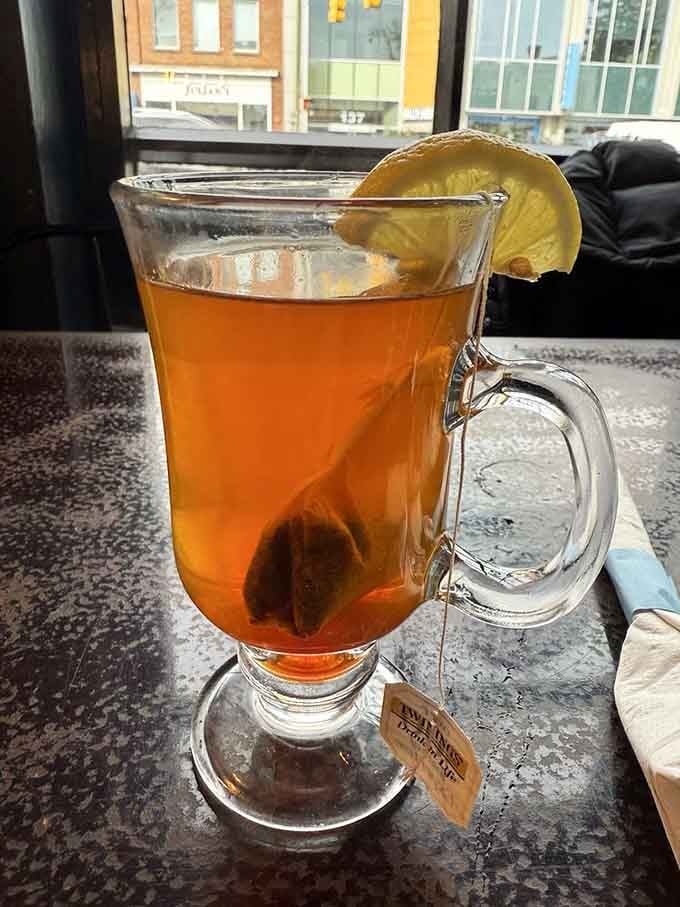 Hot tea served in a proper glass mug with lemon proves even simple beverages get the thoughtful treatment here.