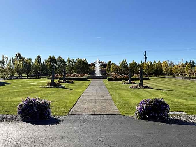 Manicured lawns stretch toward the fountain, creating symmetry that would make any landscape architect weep with joy.