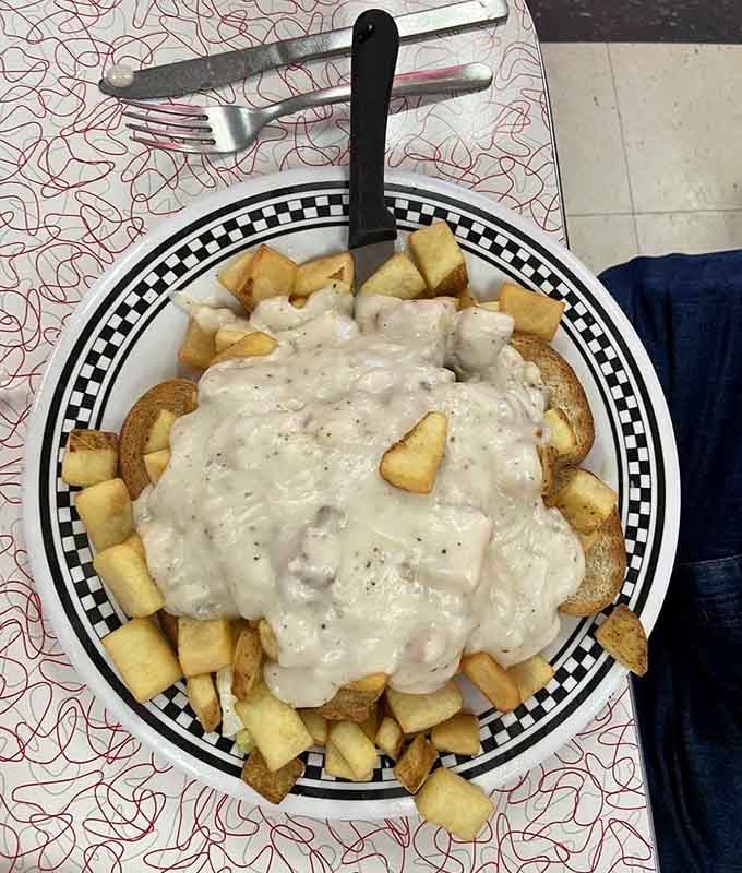 Chicken fried steak with fries and gravy, a plate that requires strategic planning and possibly a nap afterward.