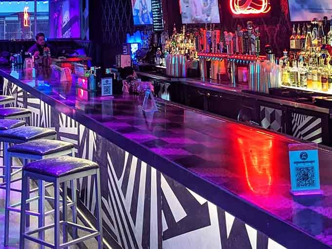 The sleek bar counter practically glows with possibility, each tap handle representing another excuse to stay longer.