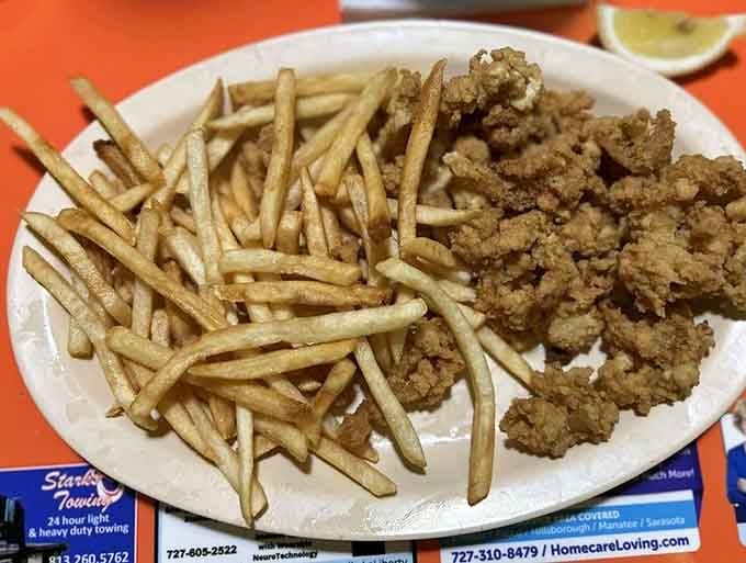 Clam strips and fries team up like the buddy cop movie of fried seafood, crispy perfection everywhere.