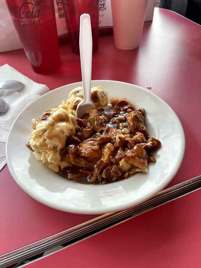 Bread pudding with ice cream and enough caramel sauce to make your dentist schedule an extra appointment just looking at it.