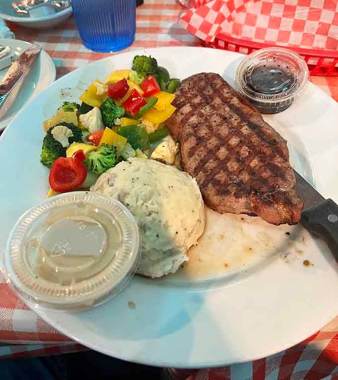 That steak with colorful vegetables looks like it wandered off a magazine cover onto your very lucky plate.
