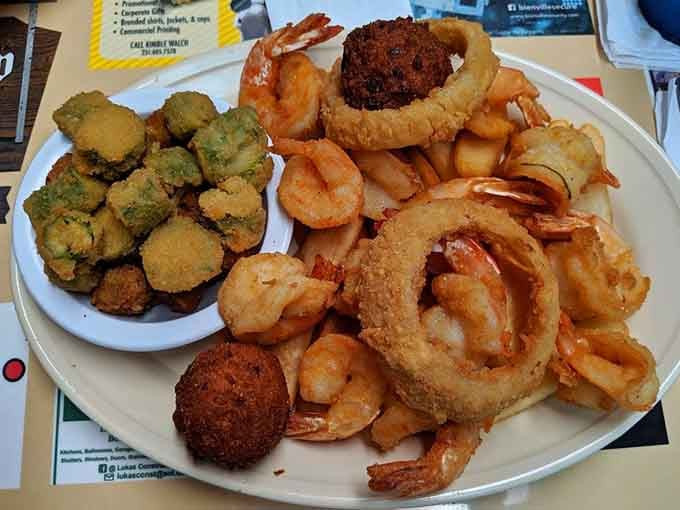 A seafood platter showcasing Gulf Coast treasures: fried shrimp, hush puppies, and enough variety to satisfy any craving.