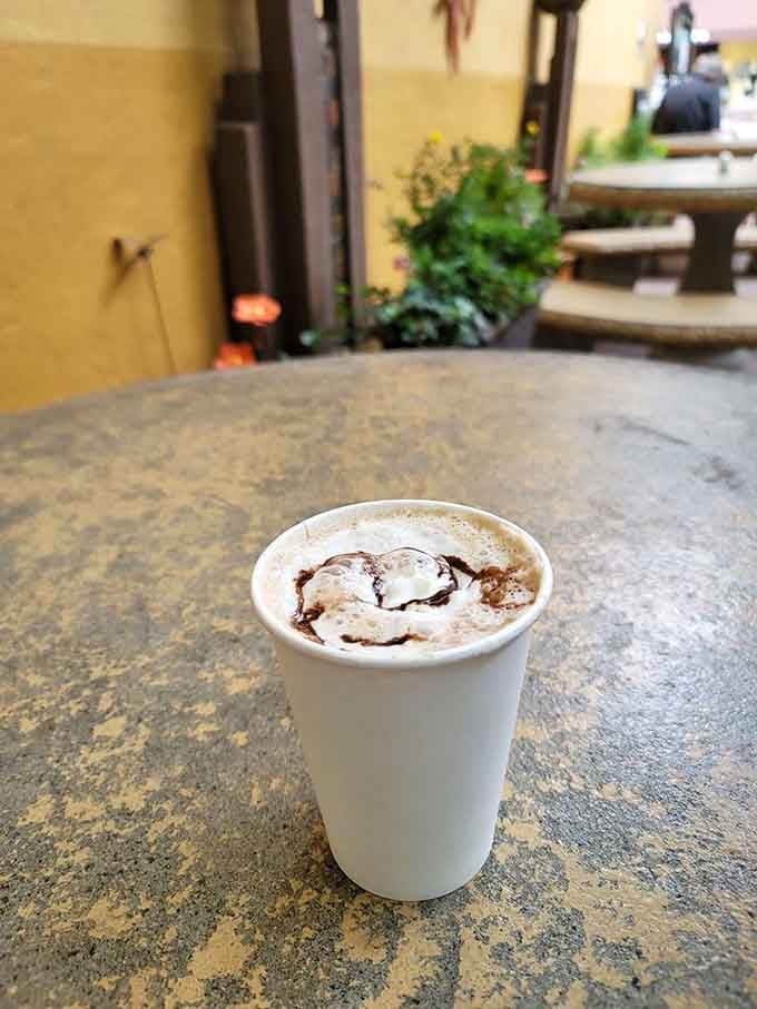 Peppermint bark mocha topped with chocolate drizzle, because sometimes you need dessert disguised as your morning coffee fix.