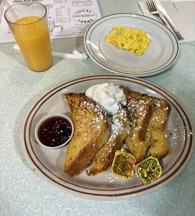 French toast dusted with powdered sugar and topped with whipped cream makes mornings worth celebrating with pure joy.