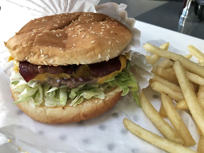 Sesame seed bun, fresh lettuce, melted cheese, this burger assembly could make a grown person weep with joy.